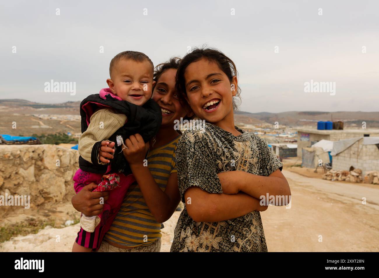 Syrian children play near a group of camps for internally diplaced ...