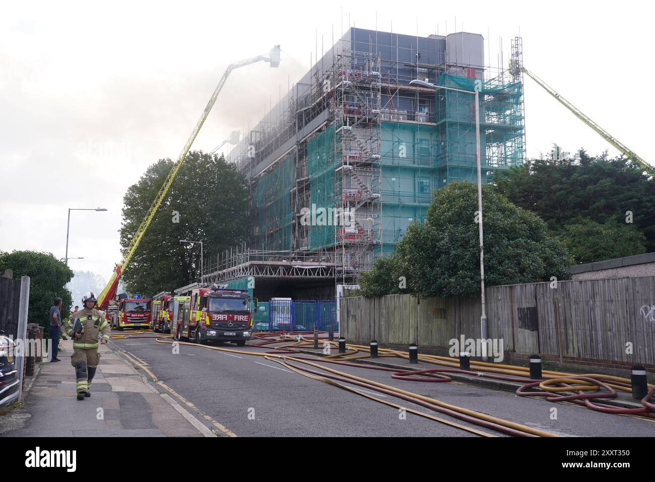 Firefighters at the scene after a blaze at a block of flats on ...