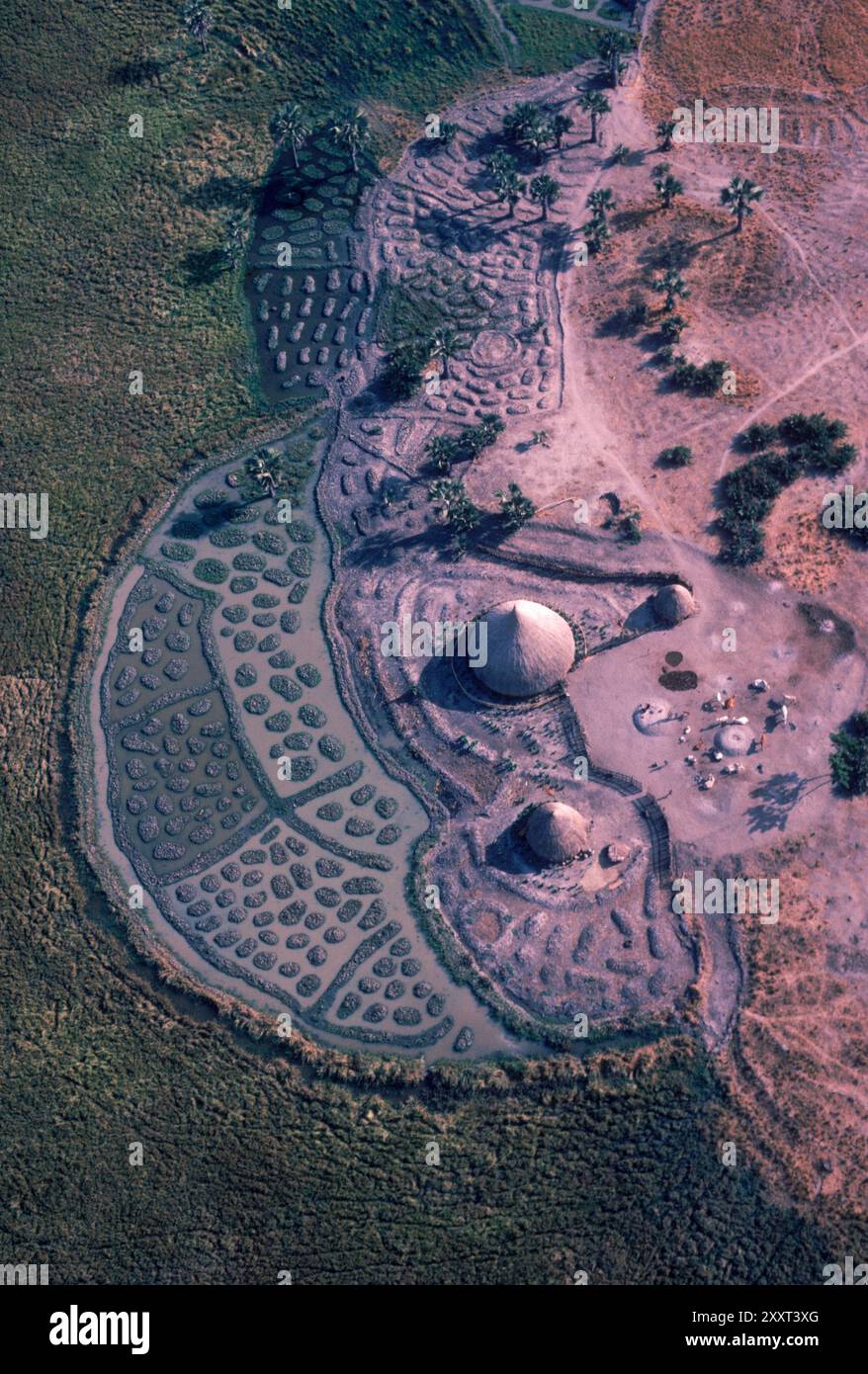 Aerial of a Nuer compound where hut is surrounded by raised sorghum ...