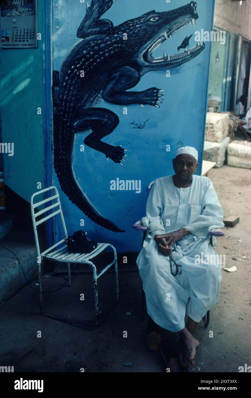 A merchant sits outside his shop in the bazaar area, Sudan Stock Photo ...