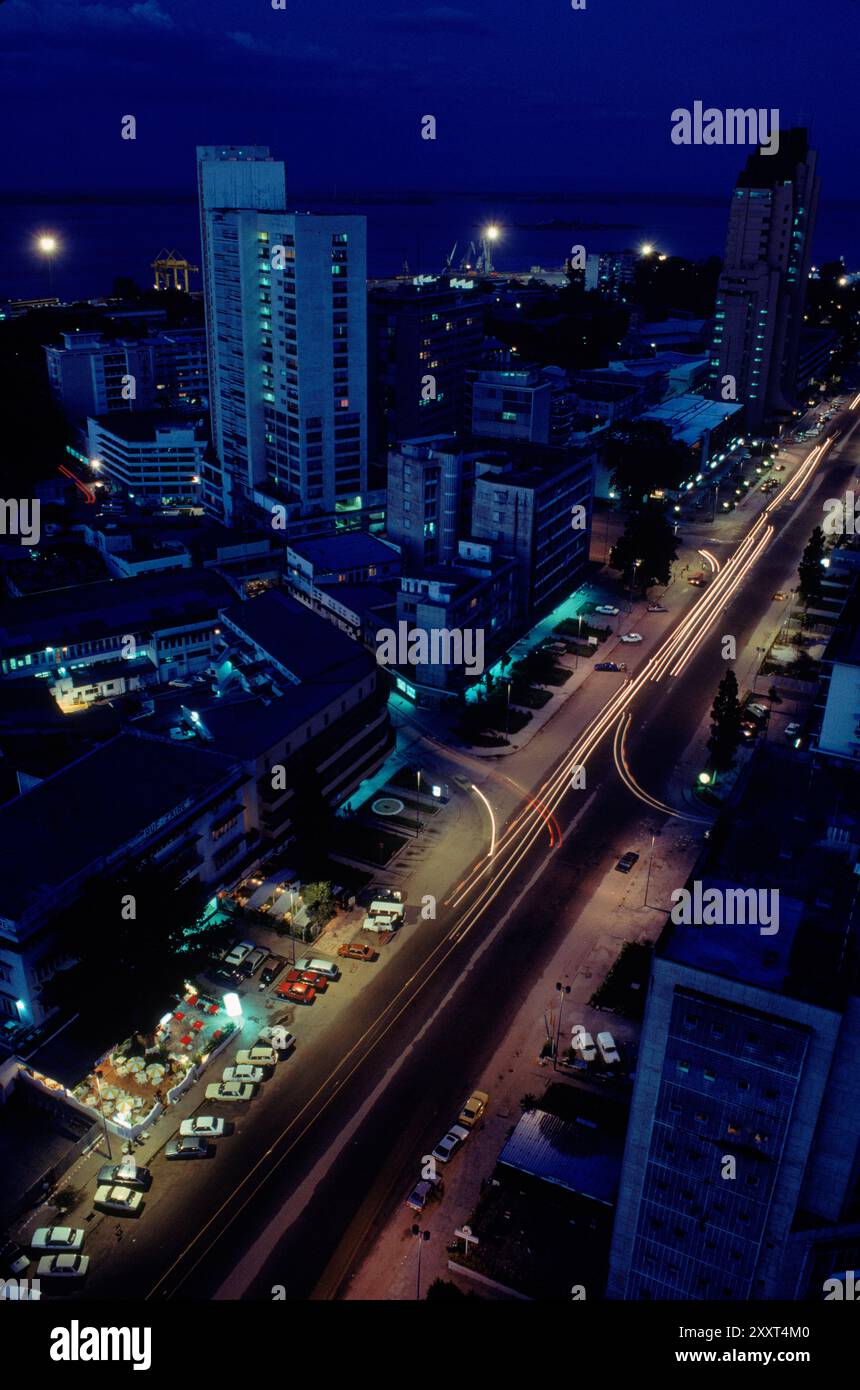 Scene of downtown Kinshasa at dusk showing the main street, the 20th ...