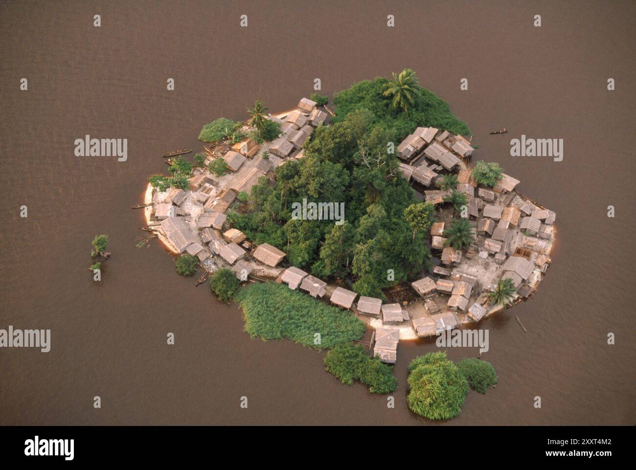 Village huts crowd a small island on the Congo River near its mouth ... Village huts crowd a small island on the Congo River near its mouth ...