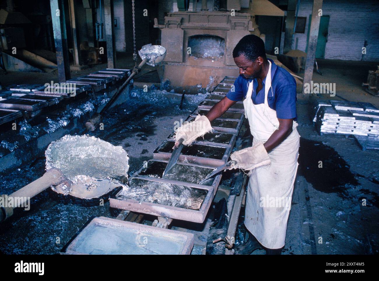 Zinc is poured into forms to make bars at a smelter in Shaba province ...