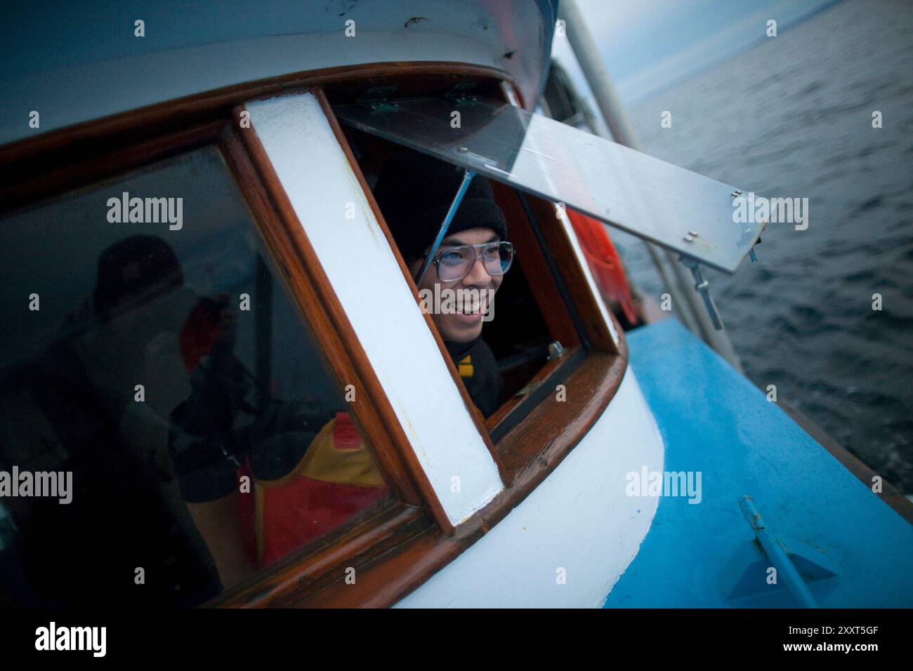A man pilots his salmon gillnetting vessel Loki in Puget Sound near ...