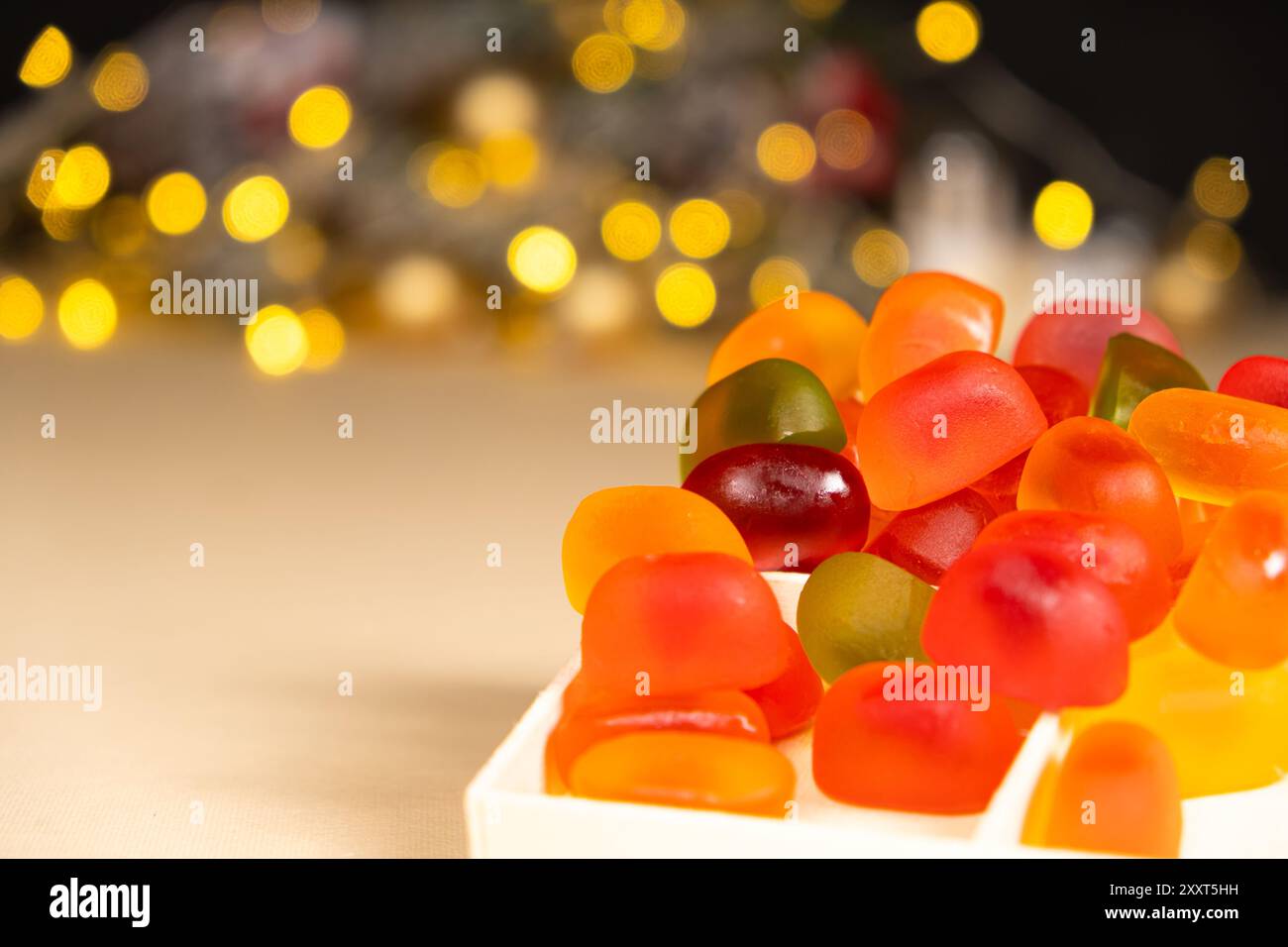 Christmas Gummy Colorful Candy on Garland Background Stock Photo - Alamy