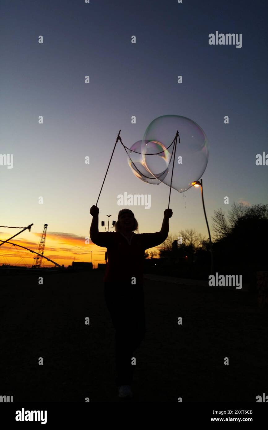 Woman making giant bubbles hi-res stock photography and images - Alamy