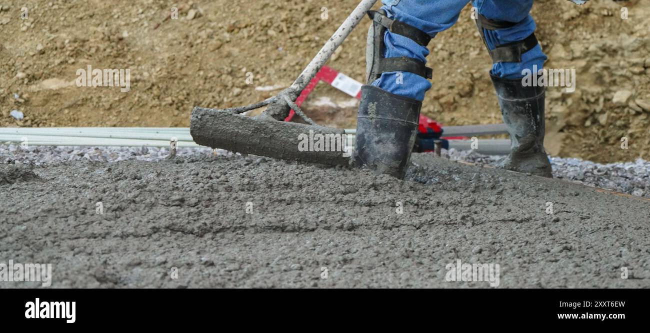 Manual spreading of concrete in a form Stock Photo - Alamy