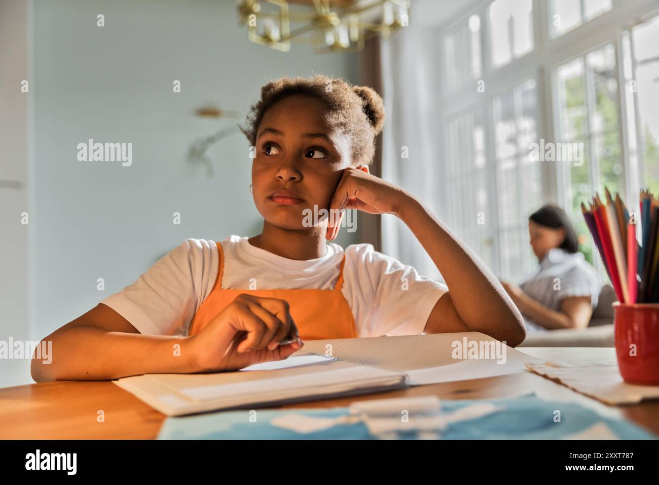African American kid girl doing homework or drawing Stock Photo - Alamy