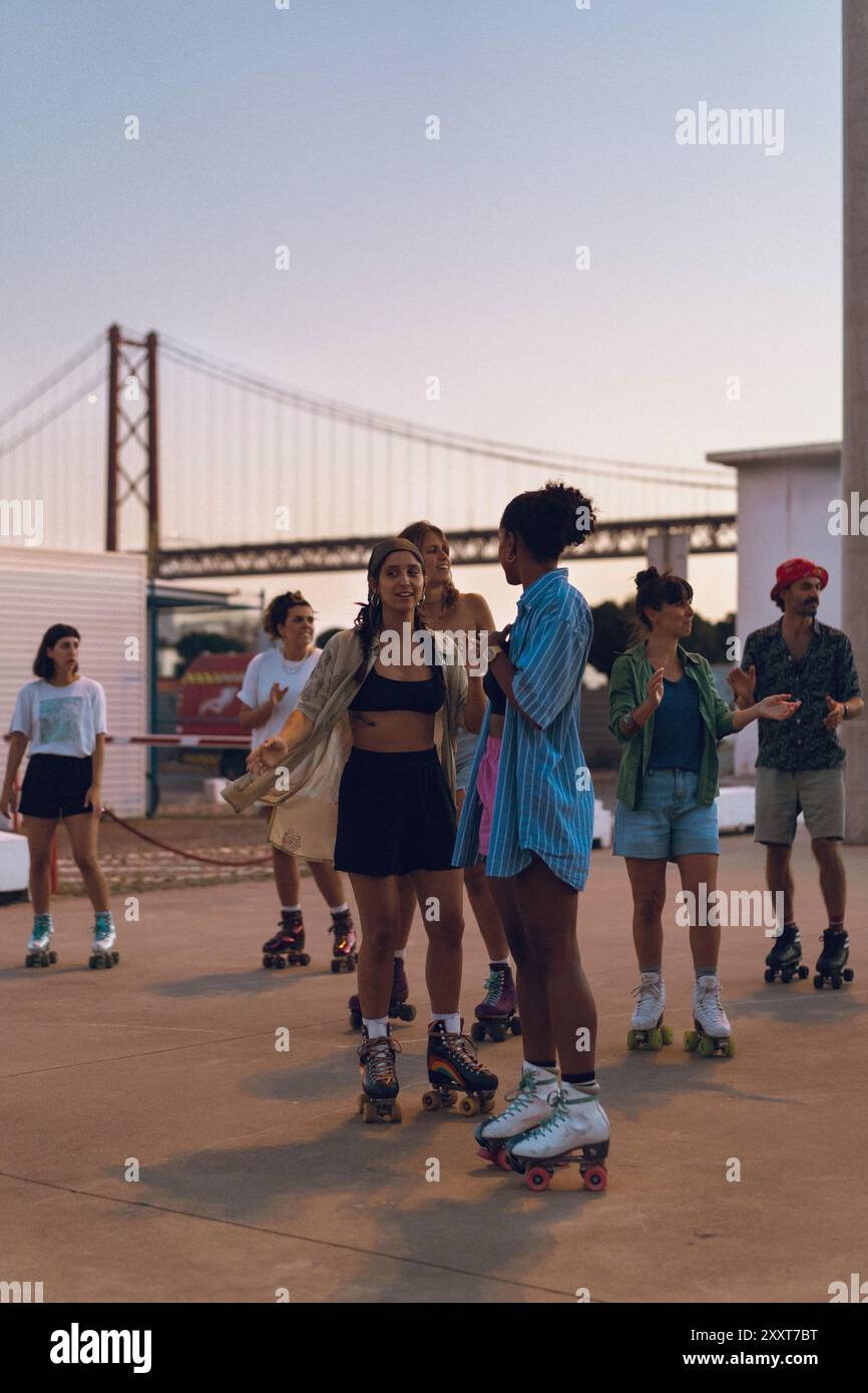 Friends roller skating on the boardwalk at sunset Stock Photo - Alamy