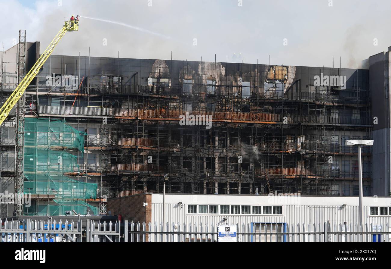 Firefighters at the scene after a blaze at a block of flats on ...