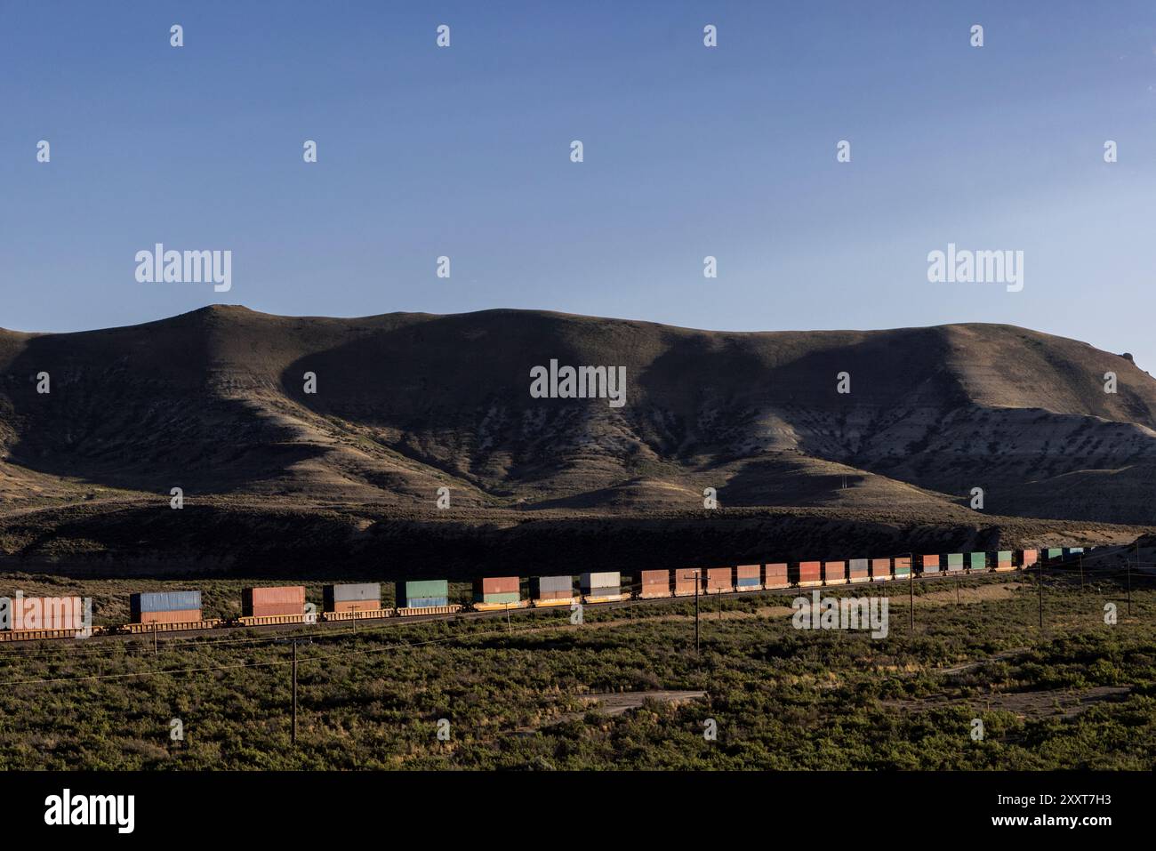 A train of container stacks trailing off from a distance Stock Photo ...