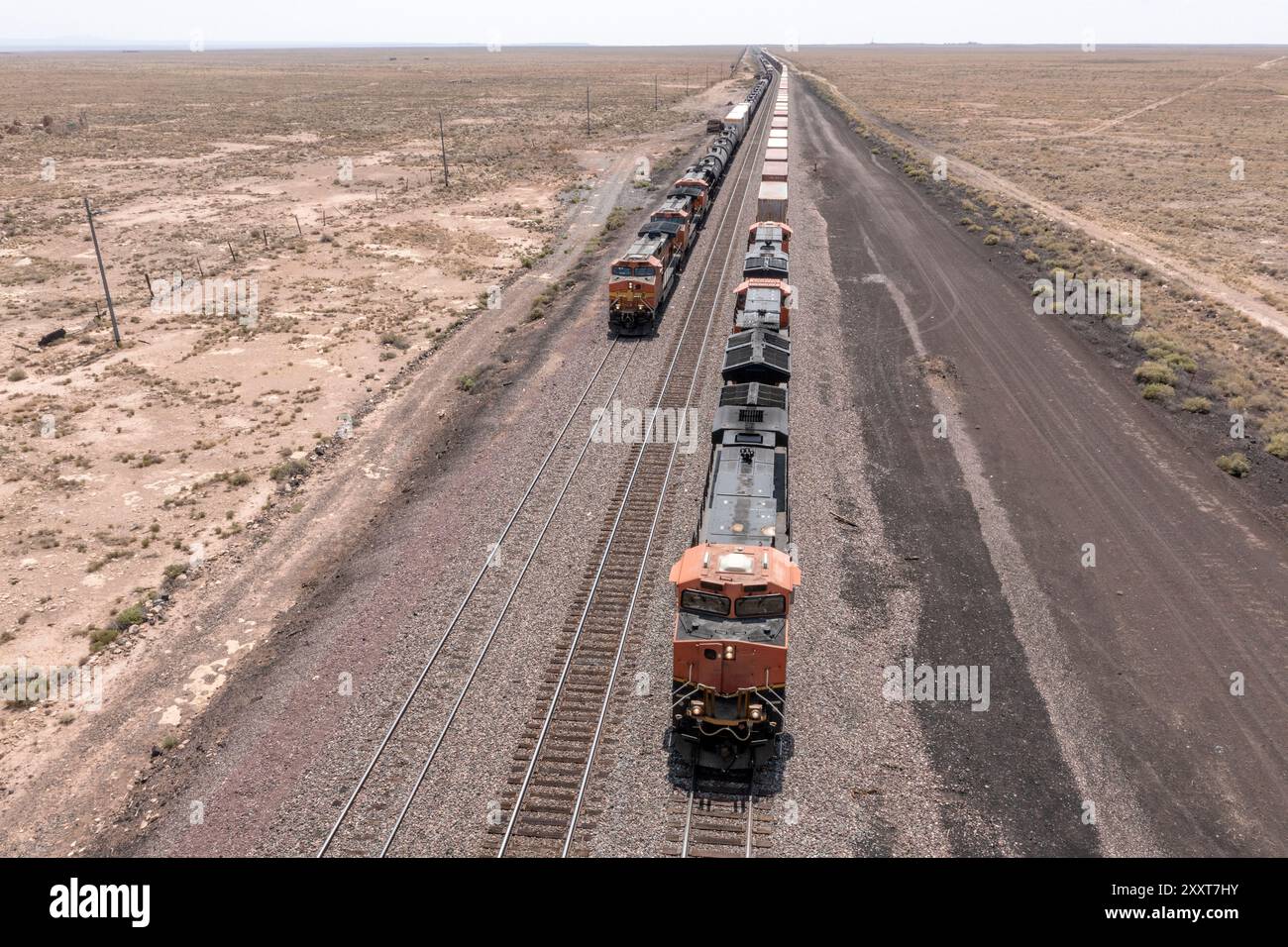 Parallel freight trains in a remote desert environment Stock Photo - Alamy