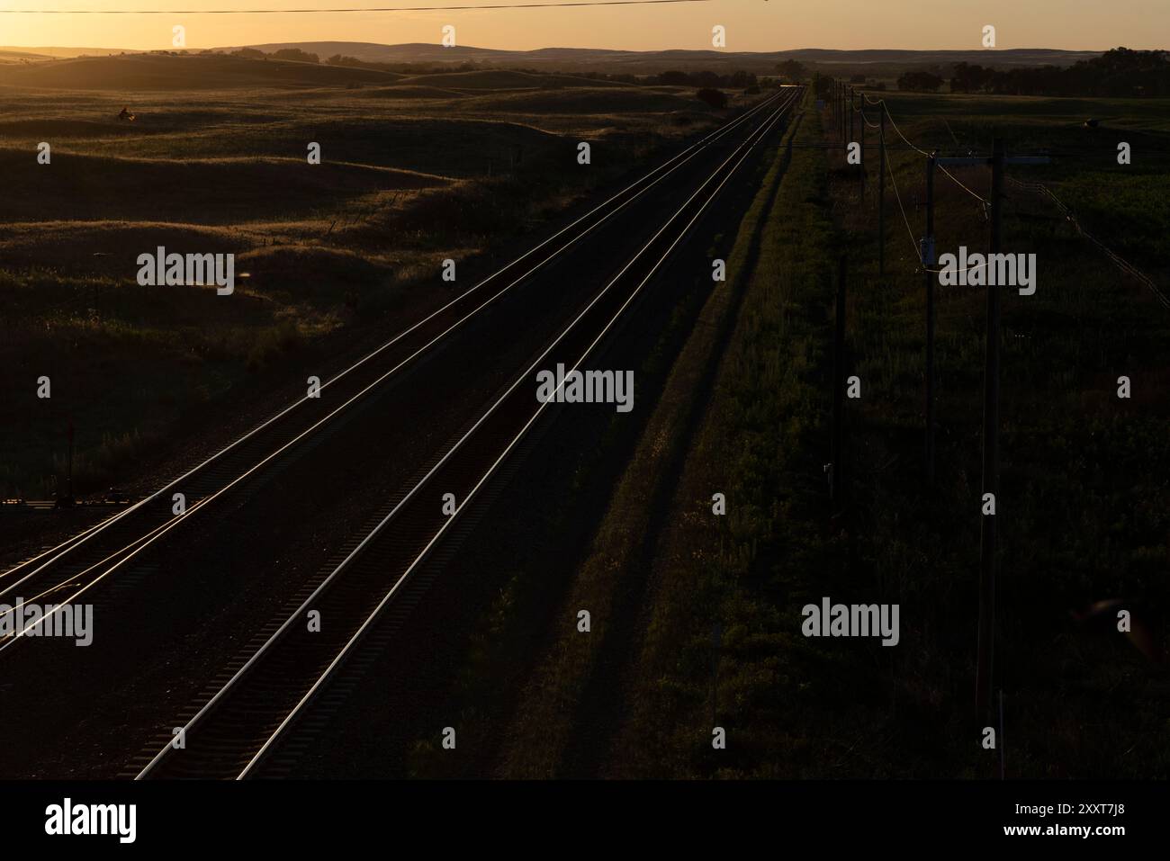 Sunset on a pastoral country landscape with train tracks Stock Photo ...