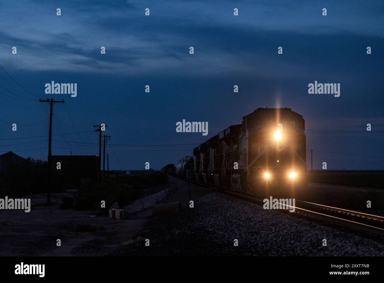 A train approaching in the blue hour light Stock Photo - Alamy