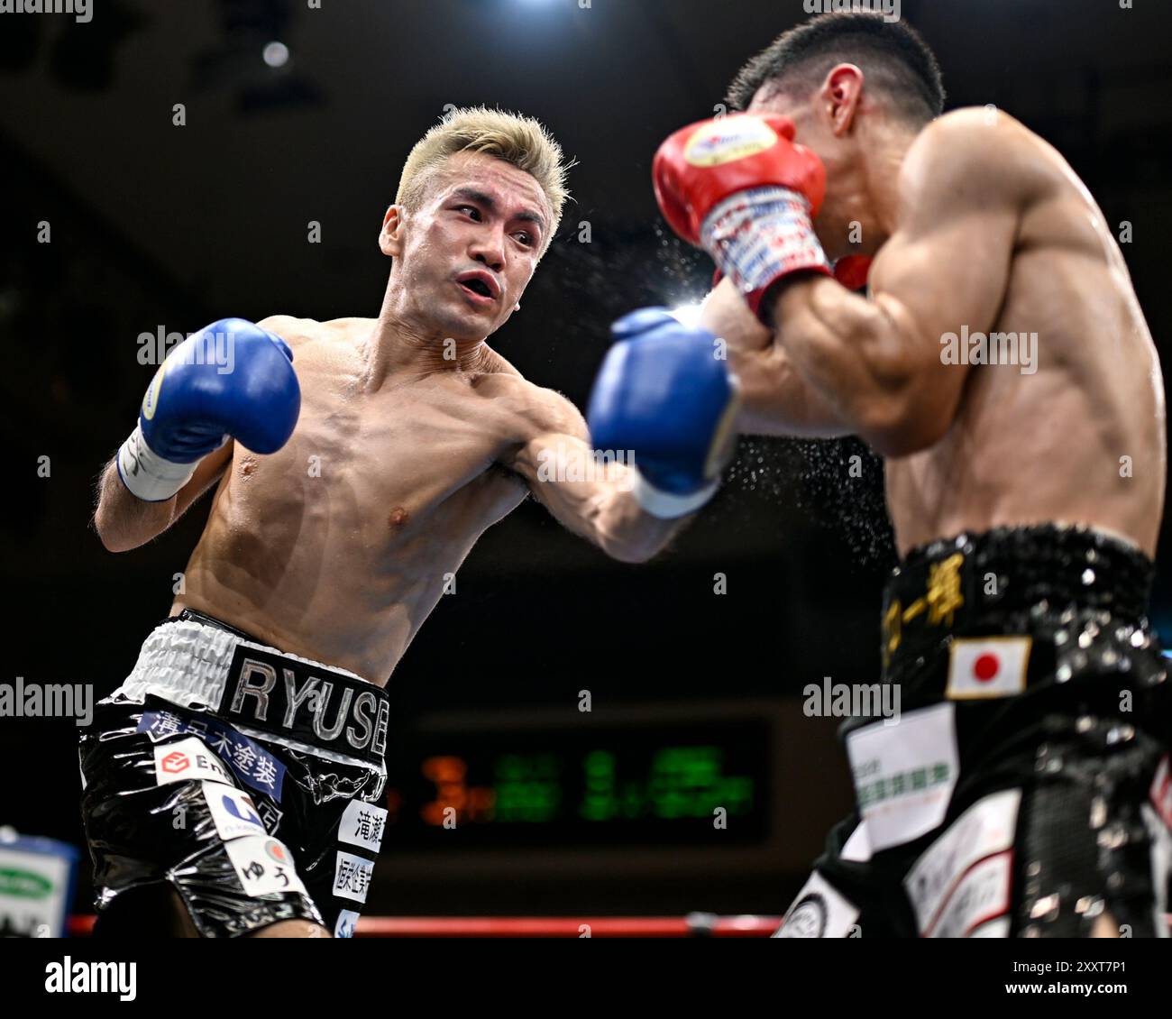 Tokyo, Japan. 13th Aug, 2024. Japan's Ryusei Kawaura (blue gloves) throws a left at Japan's ...