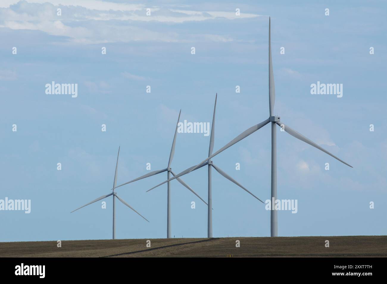 Symmetry in a row of turbines on a wind farm Stock Photo - Alamy