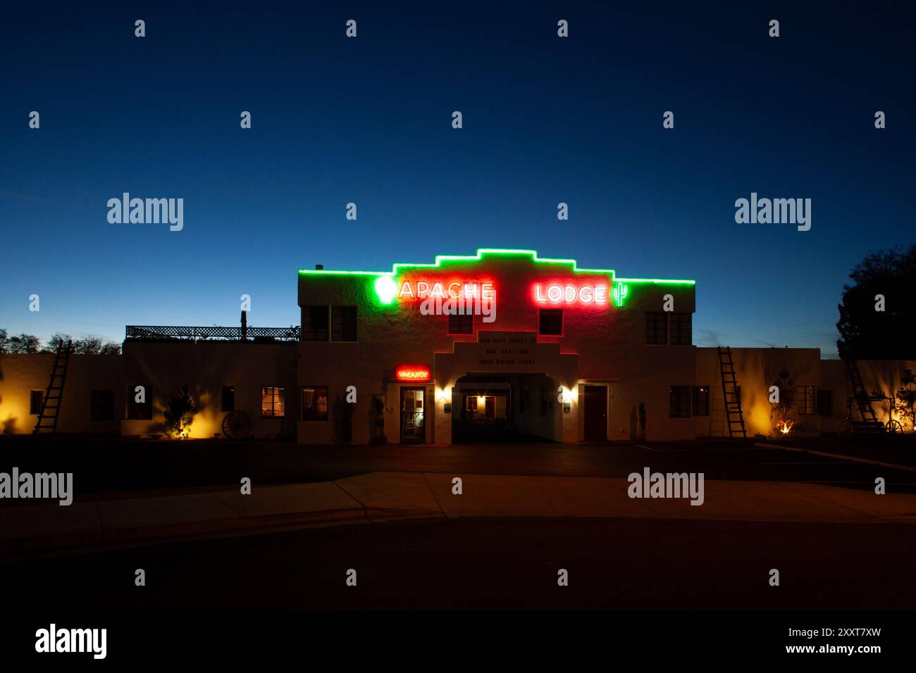 Wide view of the Apache Lodge neon glowing st dusk Stock Photo - Alamy