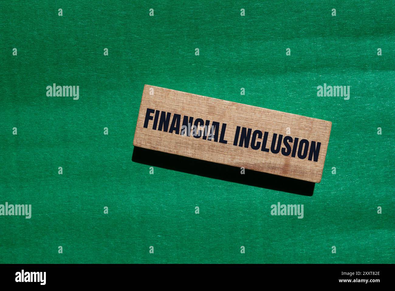 Financial inclusion message written on wooden block with green ...