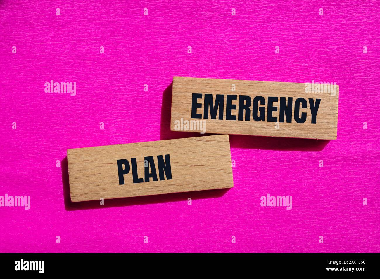 Emergency plan message written on wooden blocks with pink background. Conceptual emergency plan ...