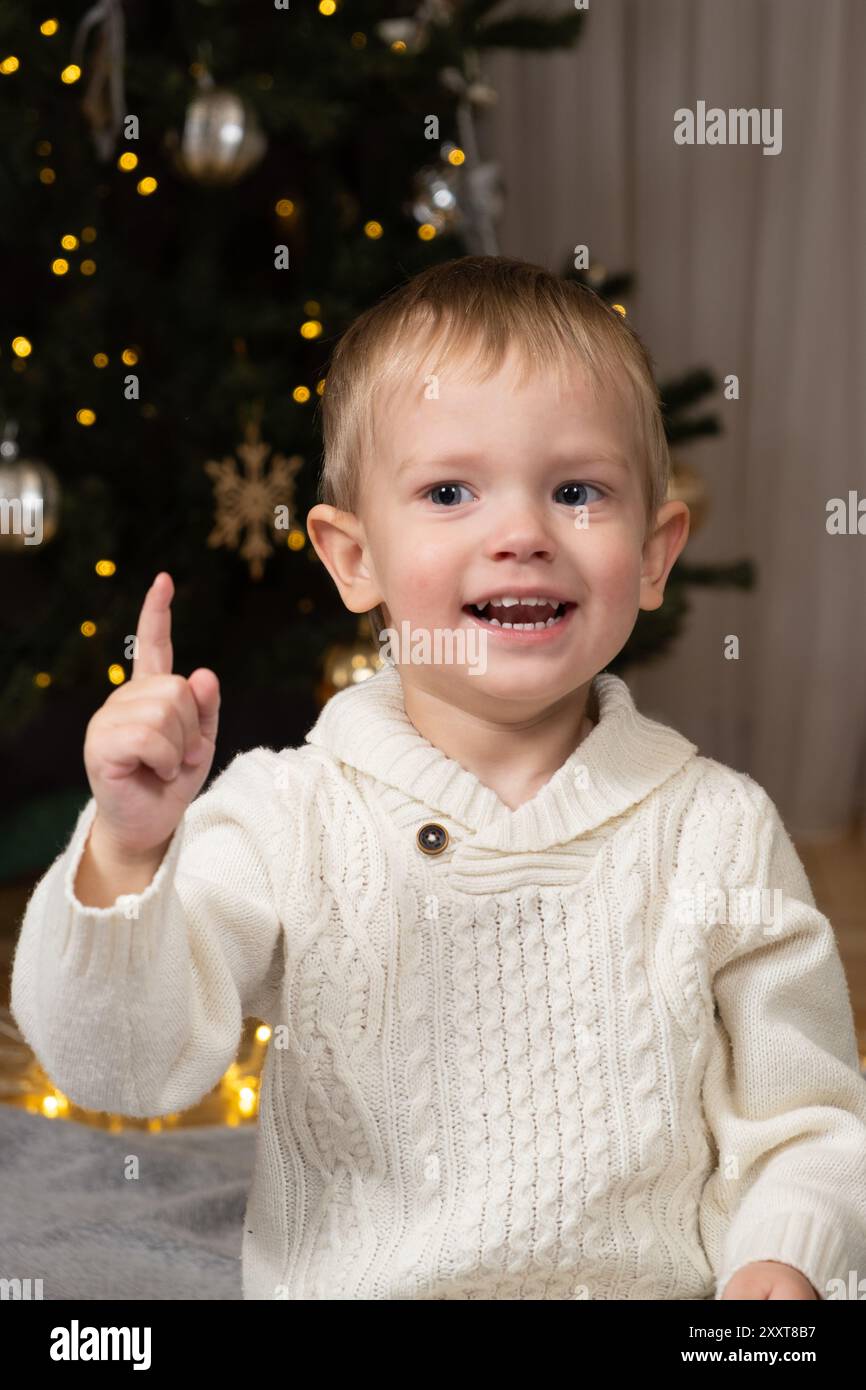 Cute little toddler showing index finger up at christmas pointing at ...