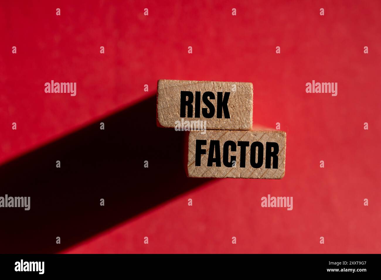 Risk factor message written on wooden blocks with red background ...