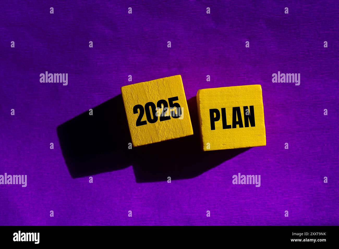 2025 plan message written on yellow wooden cubes with purple background ...