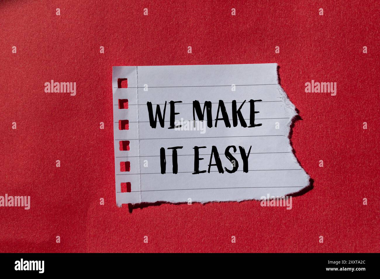 We make it easy message written on ripped paper piece with red ...
