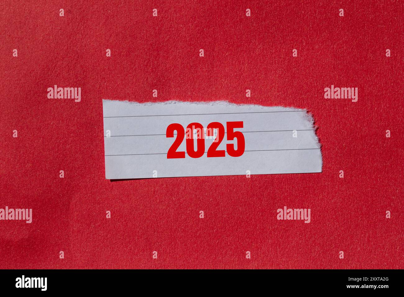 2025 message written on ripped torn paper piece with red background. Conceptual 2025 symbol ...