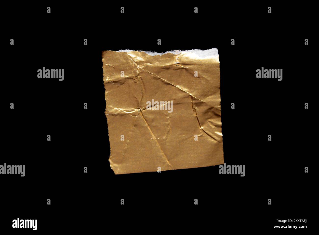 Ripped torn golden paper piece on isolated black background Stock Photo ...