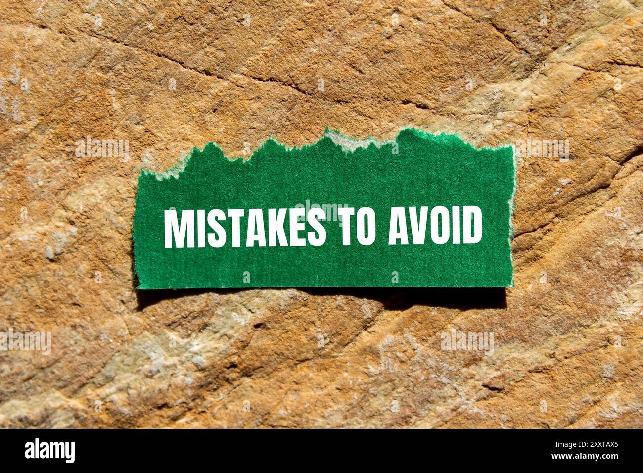 Mistakes to avoid message written on ripped torn green paper piece on ...