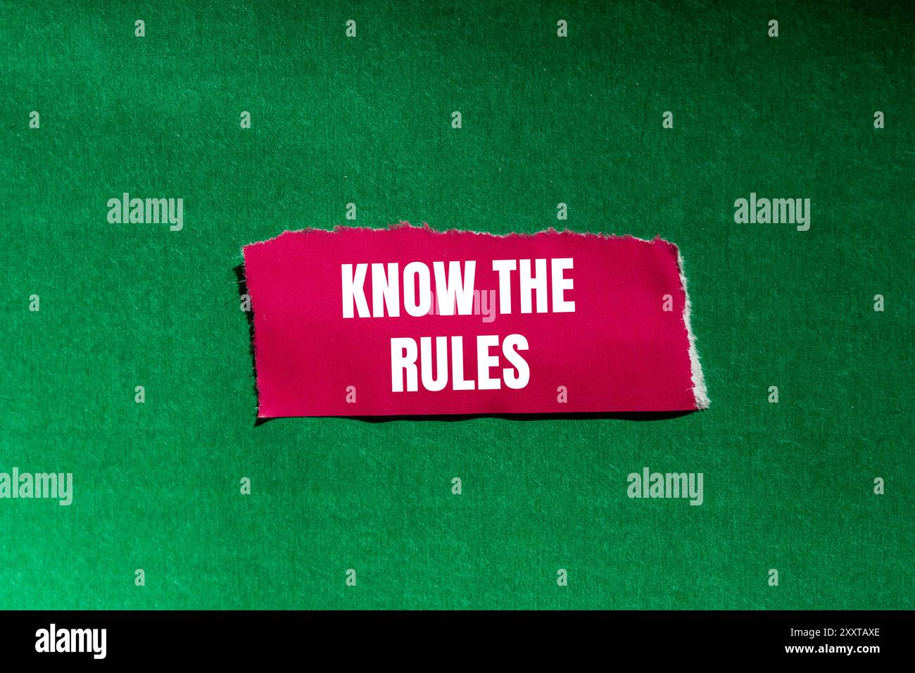 Know the rules words written on ripped torn pink paper piece on green background. Conceptual ...