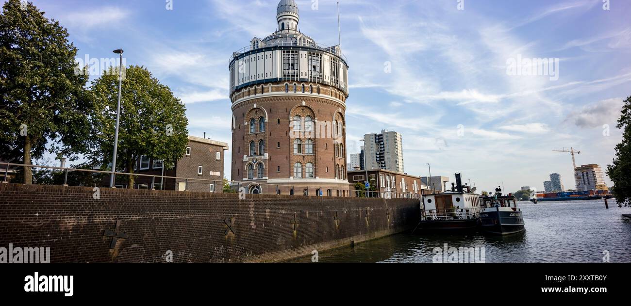 Quay with former water tower and basin with windows on a sunny day ...