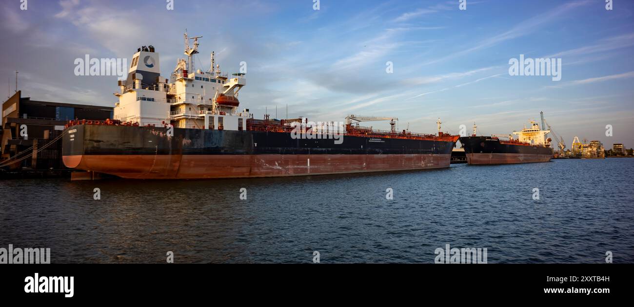Large seafarer cargo ship vessel on quay of Rotterdam harbour against a ...