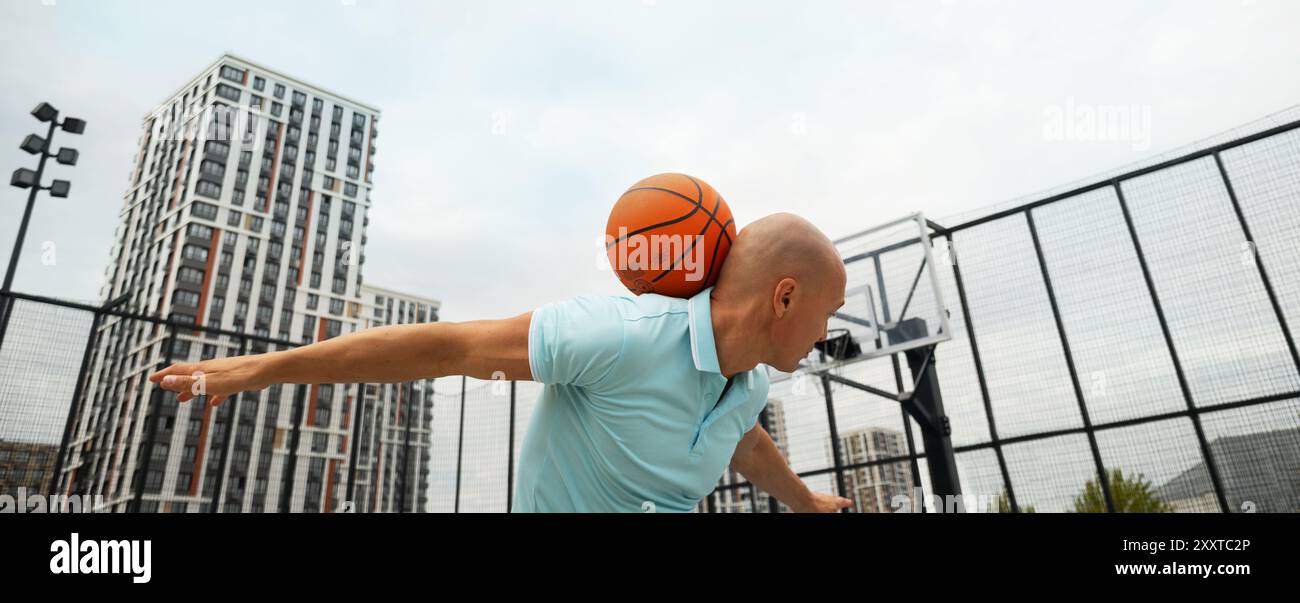Banner with sporty man playing with orange basketball ball on sports ...
