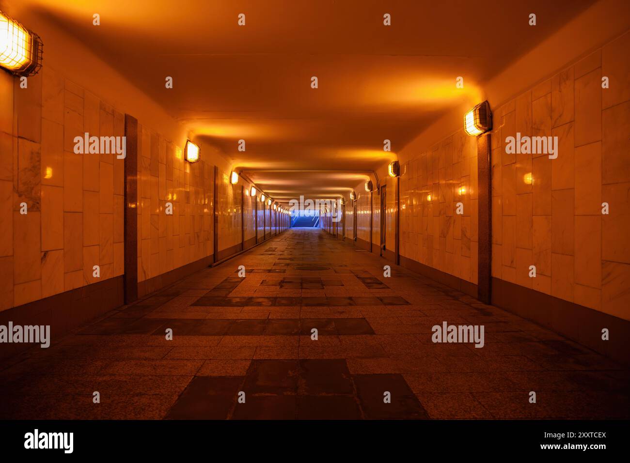 Underground passage leading to a distant exit, rhythmic lighting ...