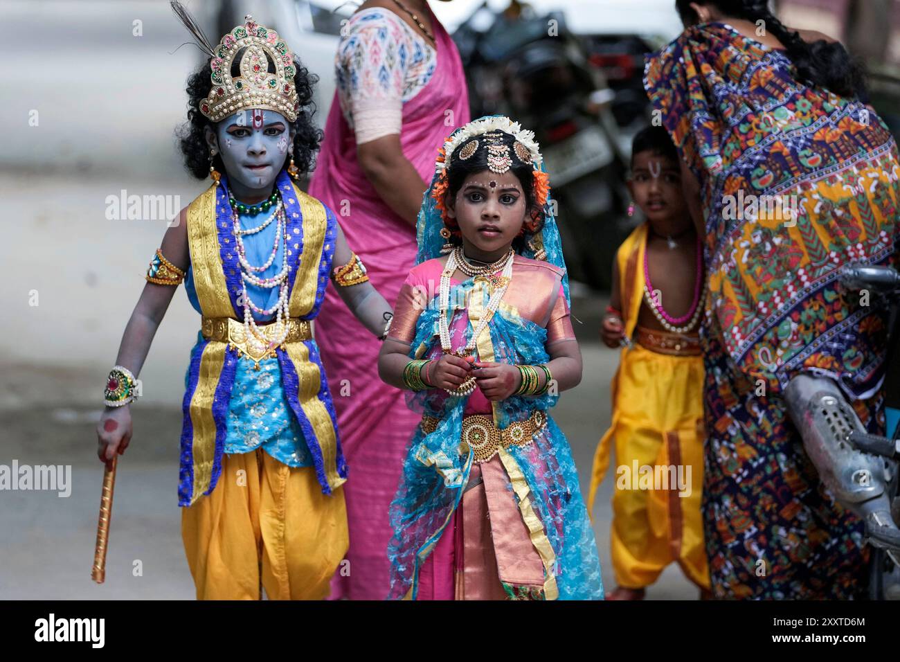 School children dressed as Lord Krishna, left and his consort Radha ...