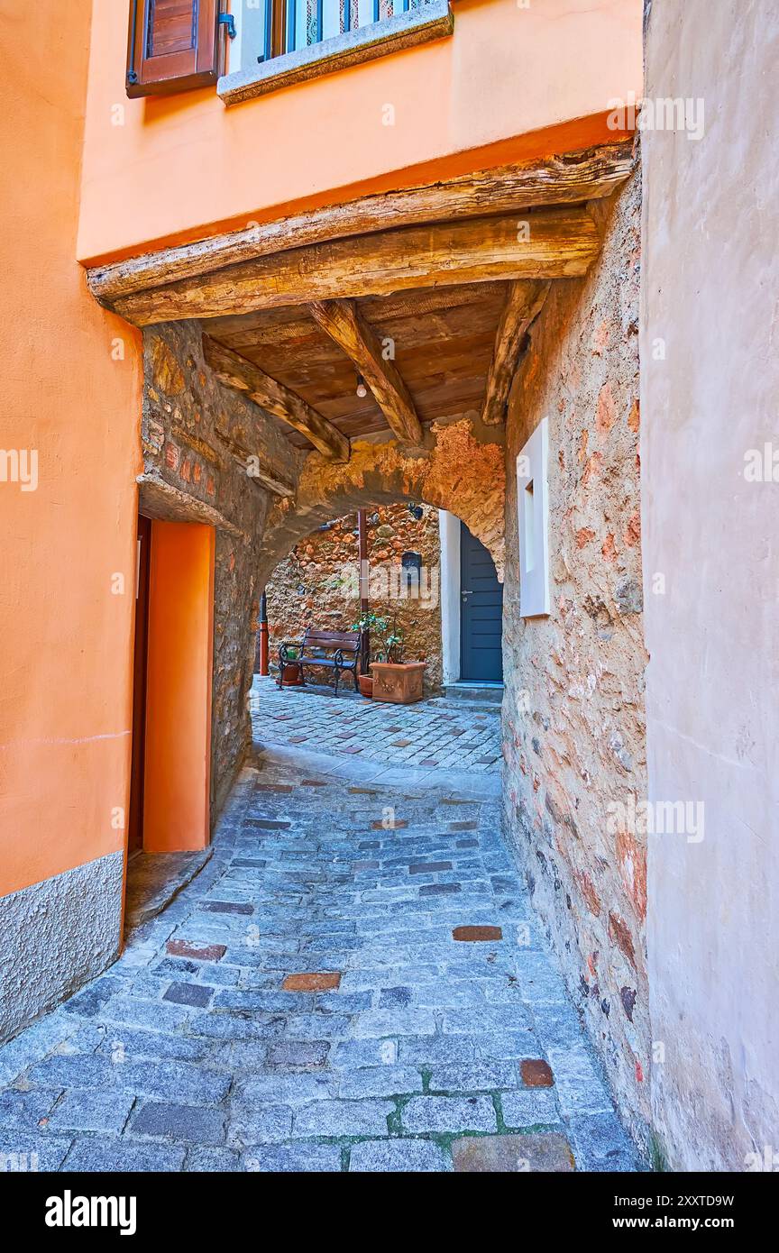 The small medieval passage under the living house in old town of Carona ...