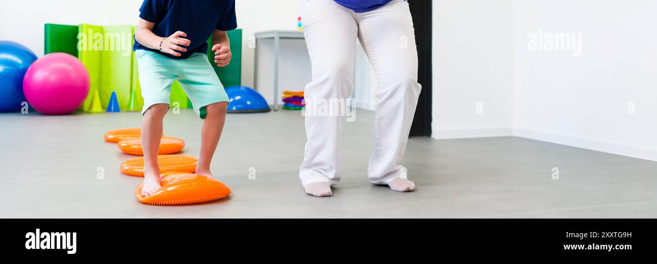 Child and female physical therapist during session. Child exercising in ...