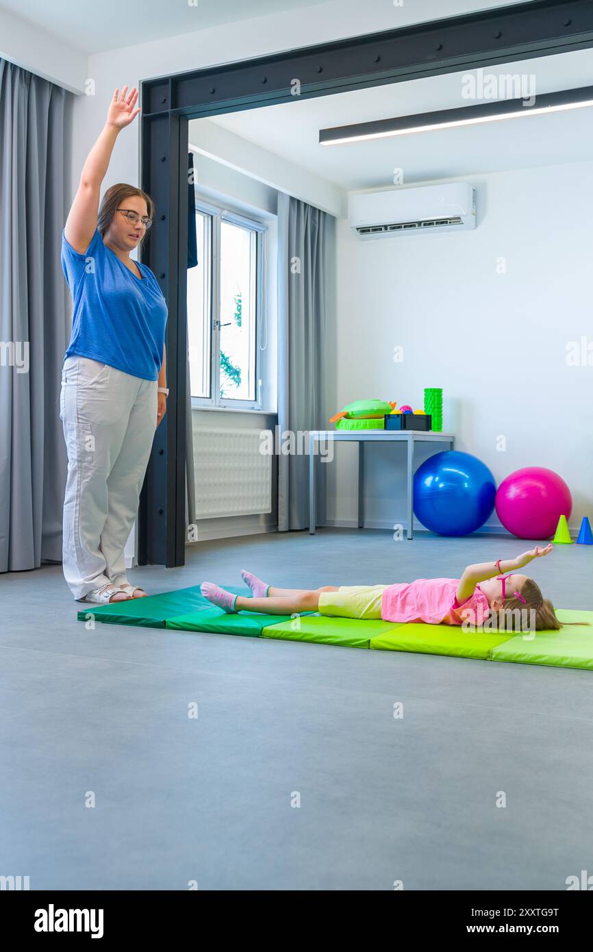 Child with physical disability in physical therapy session. Child ...