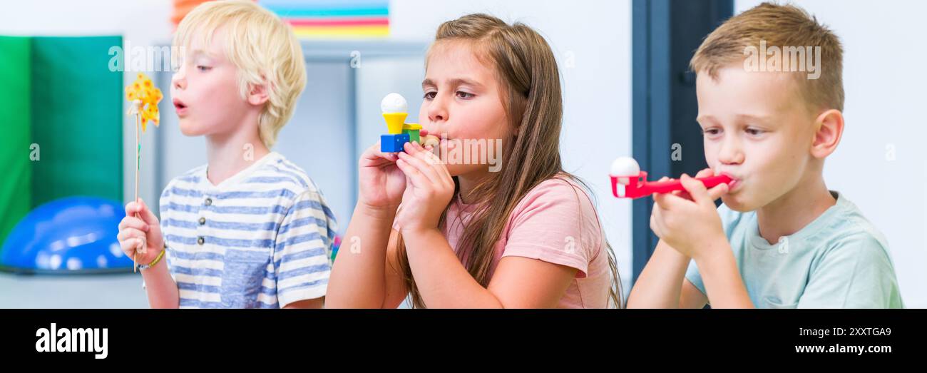 Group of young children making breathing exercises during physical ...