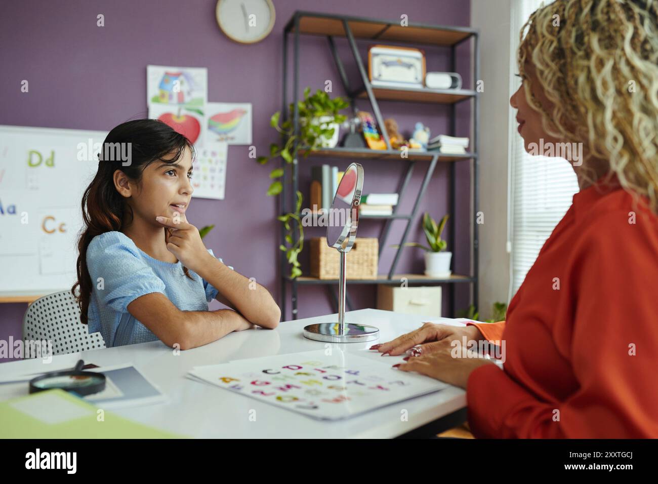 Teacher Mentoring Student Practicing Alphabet Reading Stock Photo - Alamy