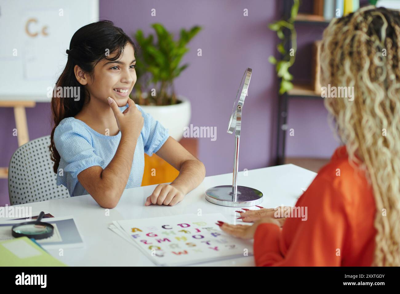 Smiling Girl Attending Classroom Tutoring Session Stock Photo - Alamy