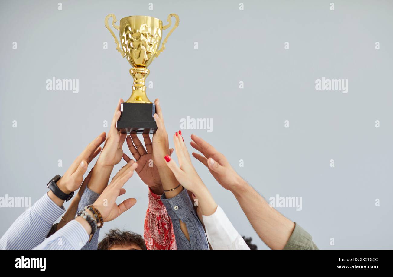 Team of employees holding golden trophy cup, receiving business award ...