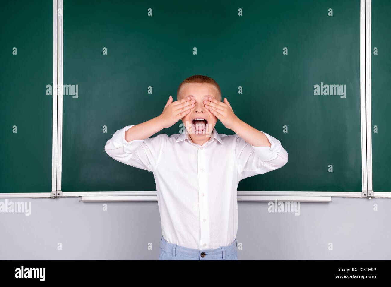 Photo of funny cheerful cute boy primary school learner standing in ...