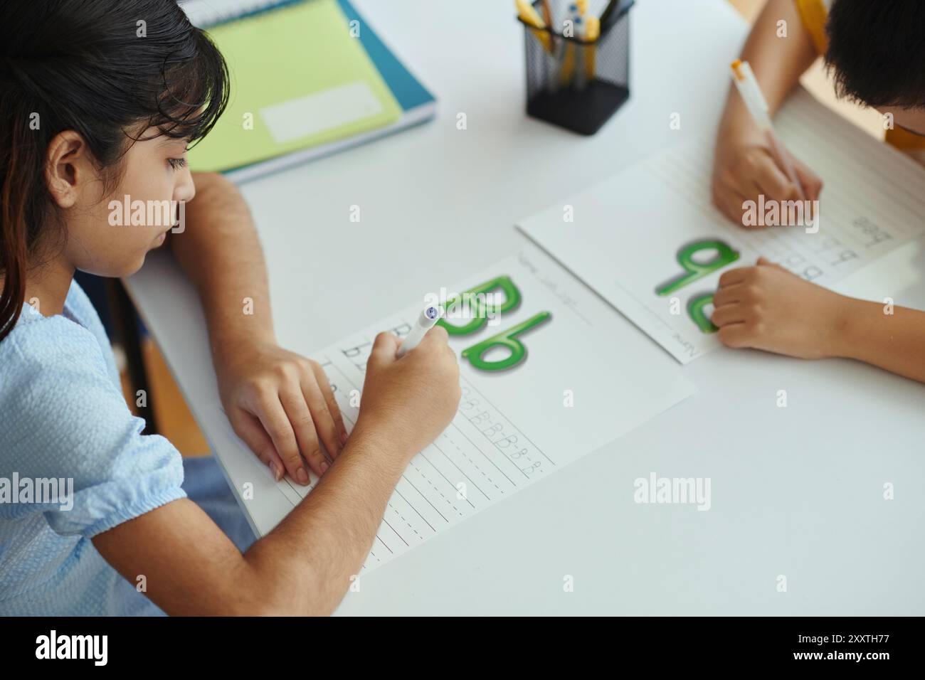 Engaging in Handwriting Practice in Classroom Setting Together Stock ...