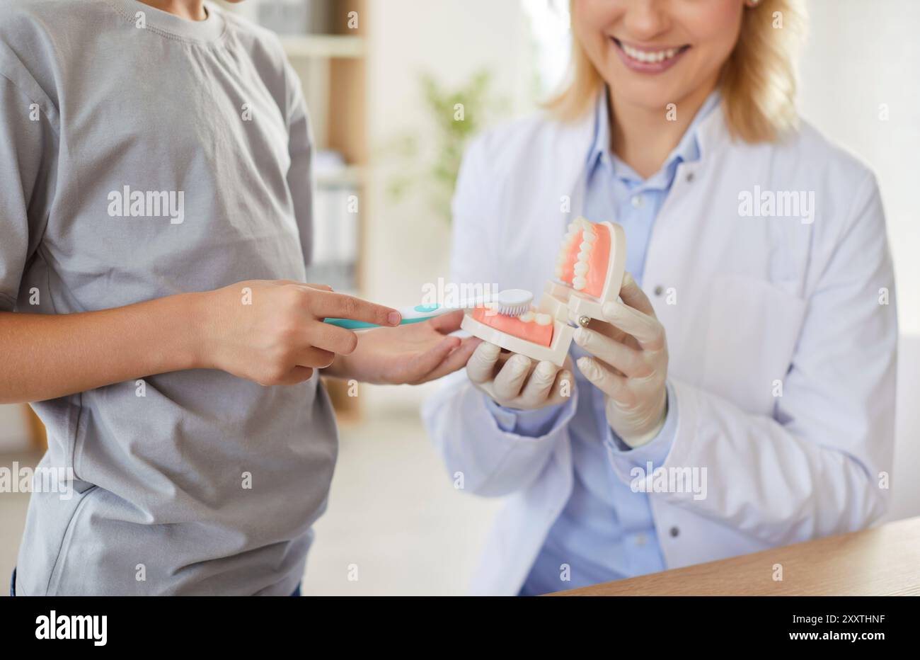 Orthodontist Holding Fake Jaw Model Teaching Little Boy Patient To