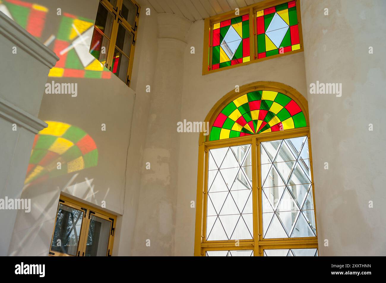 Yellow, red and green colorful lights from stained glass window on the ...