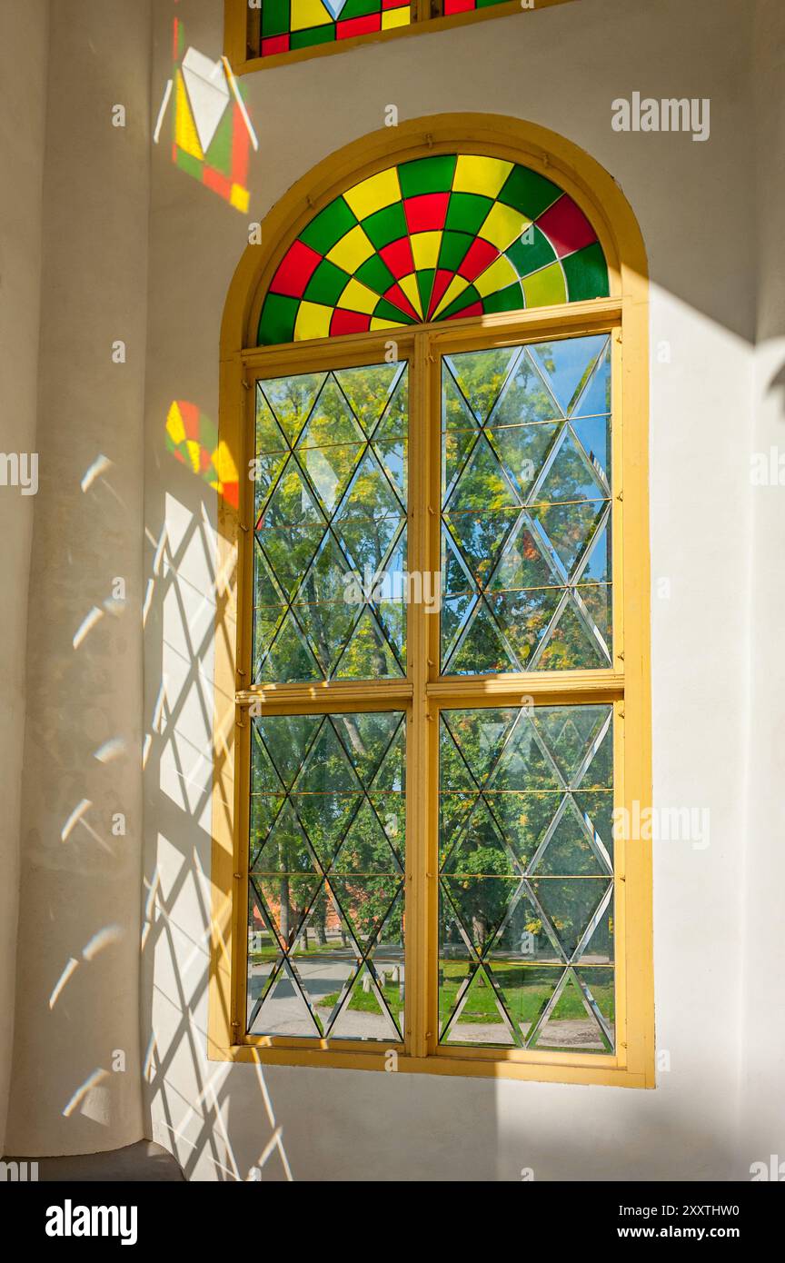 Yellow, red and green colorful lights from stained glass window on the ...