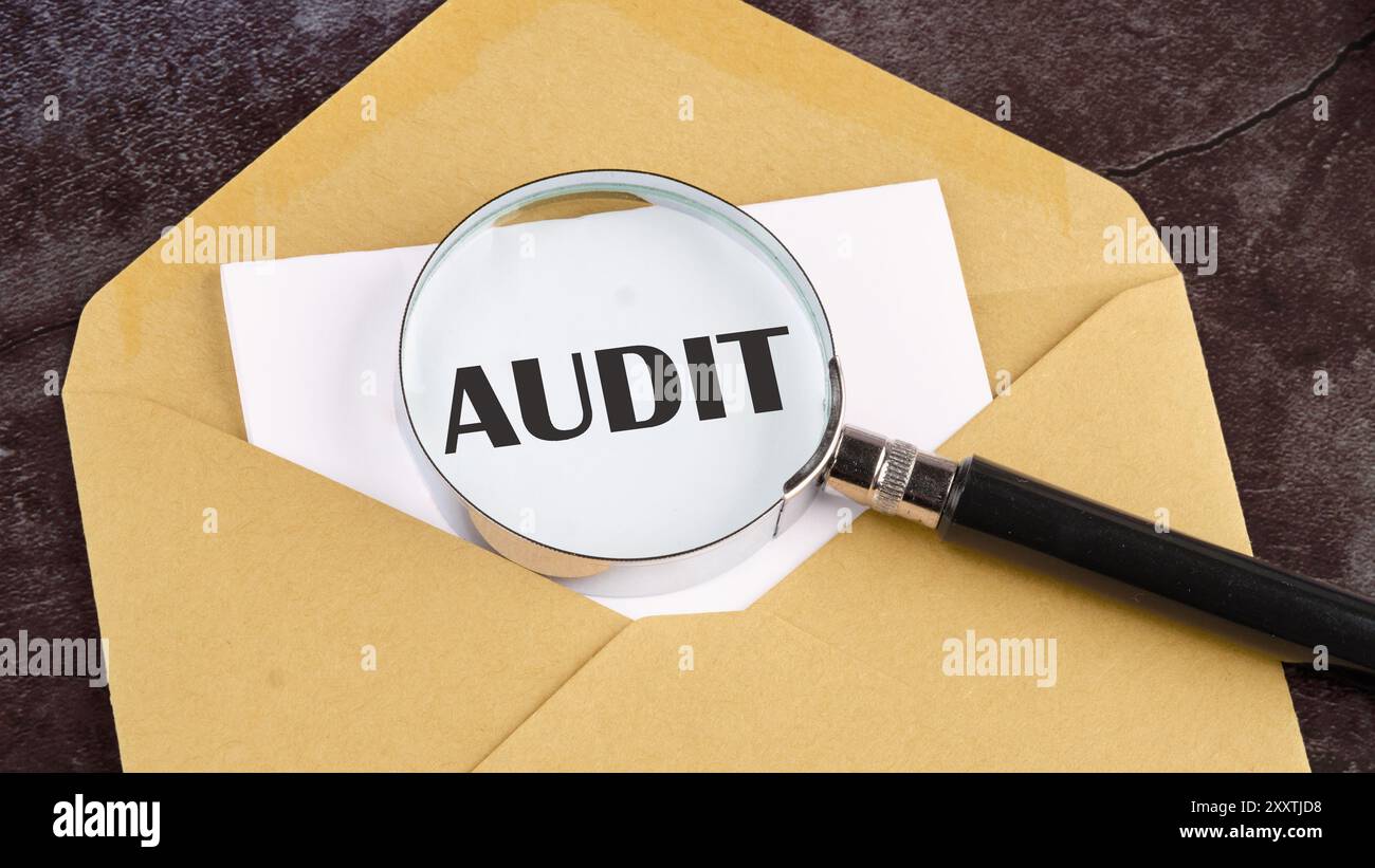Copy space and business concept. A word AUDIT written through a ...