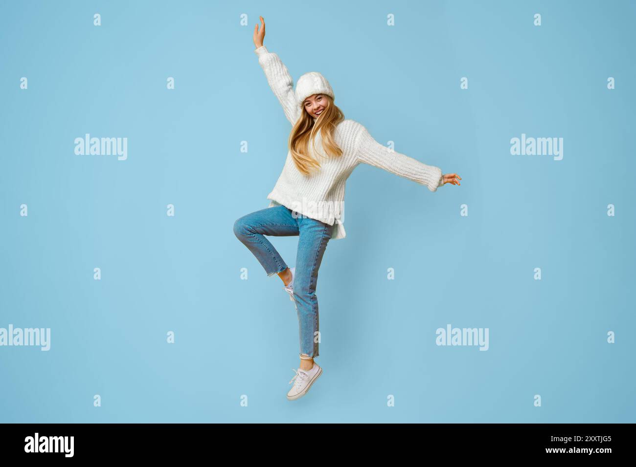 Playful winter girl having fun over yellow studio background Stock ...